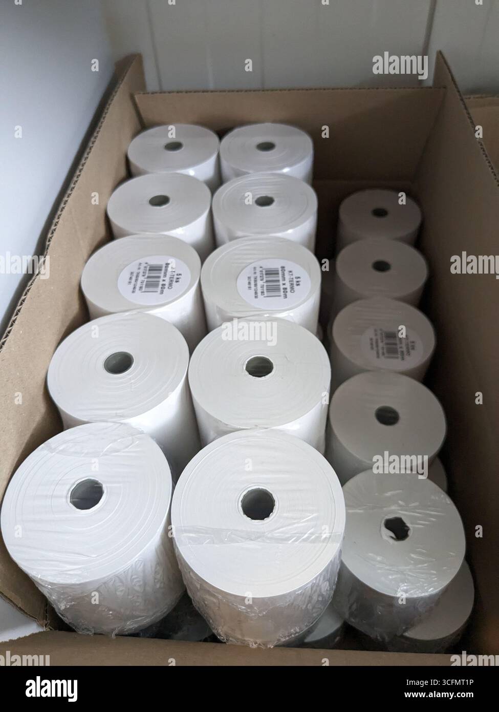 Spare thermal printer rolls for receipt printing stacked in white ...
