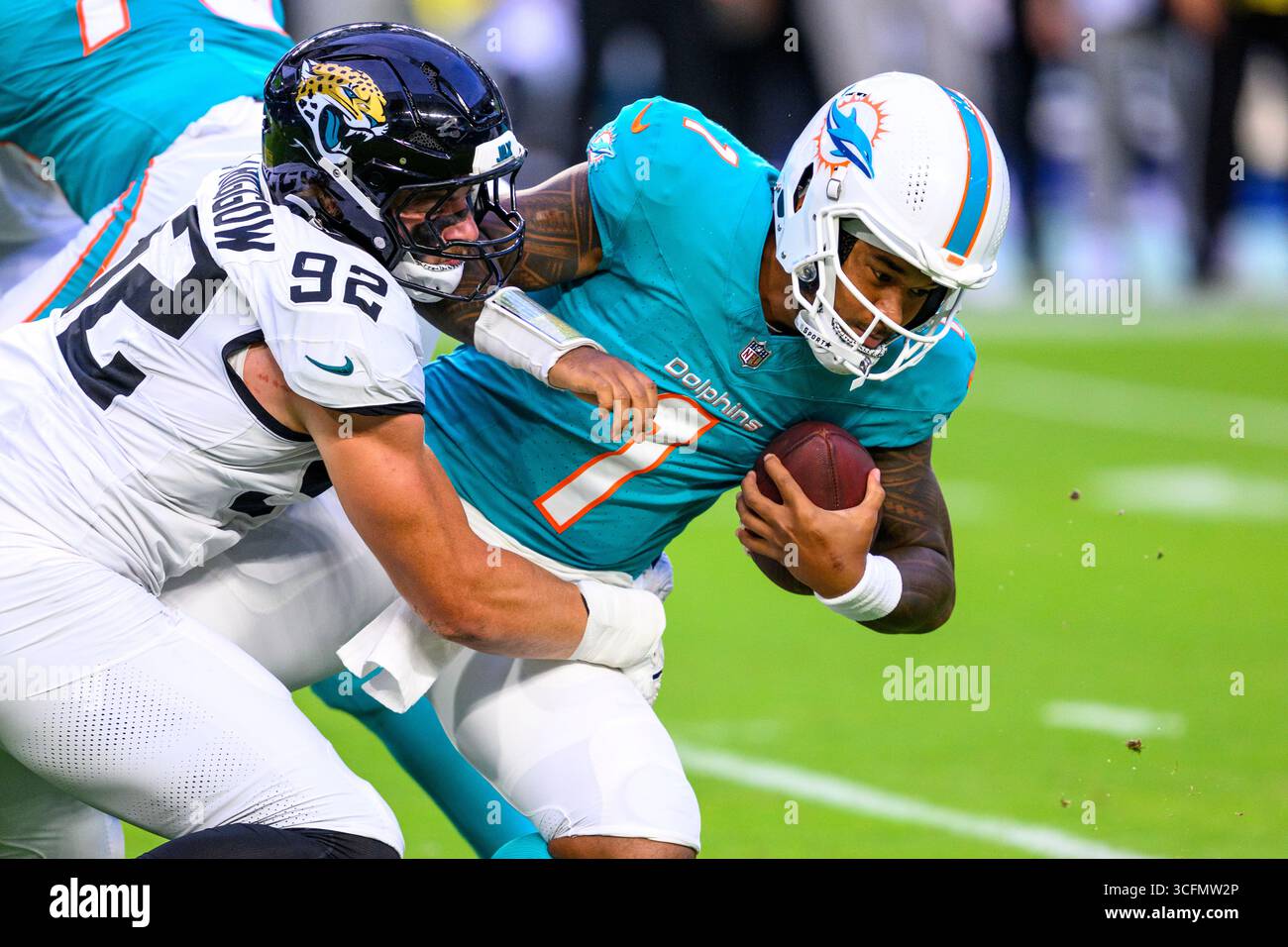 Miami Dolphins quarterback Tua Tagovailoa (1) is sacked by Jacksonville ...