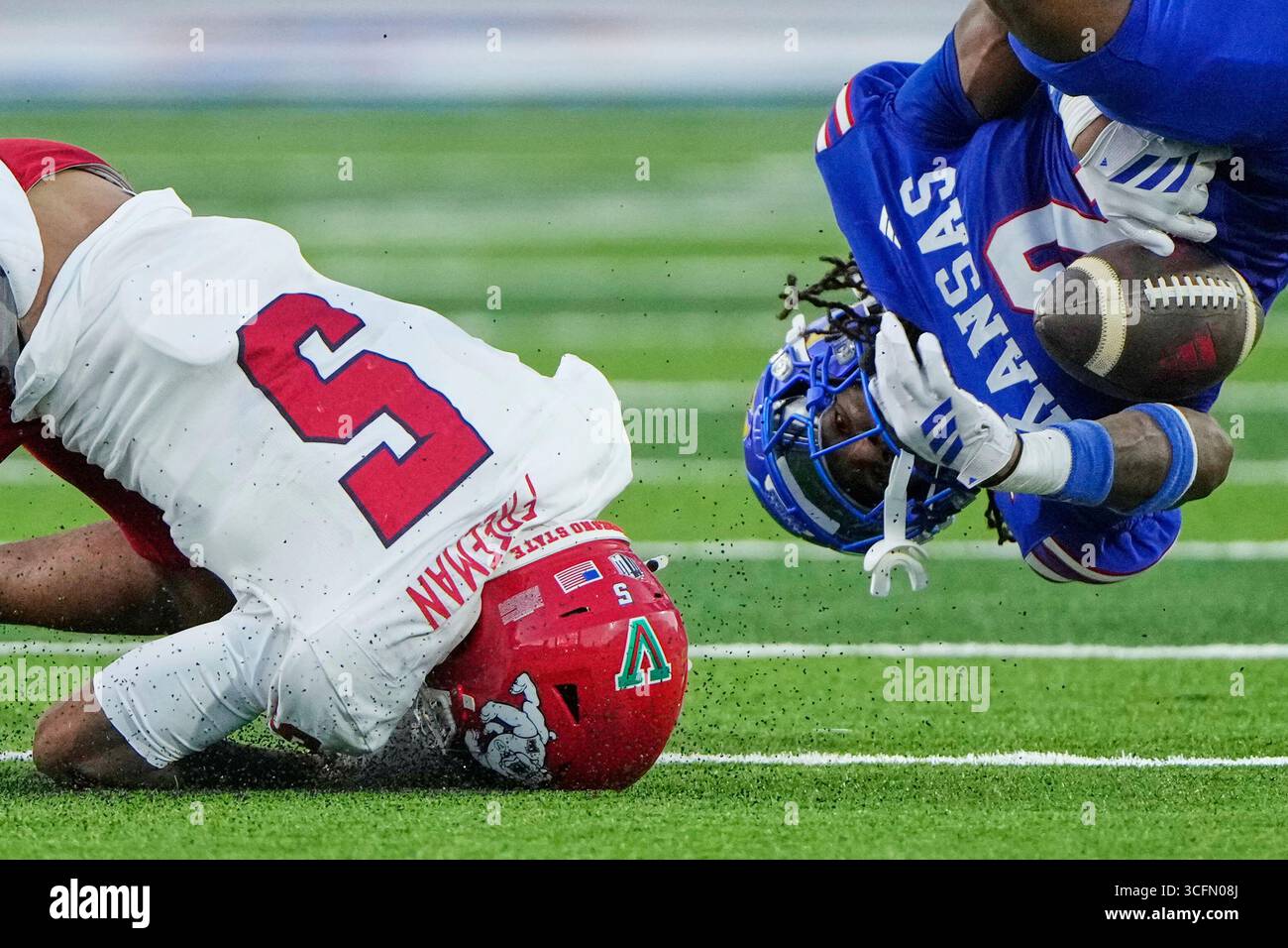 Kansas safety Lyrik Rawls (2) intercepts a pass intended for Fresno ...
