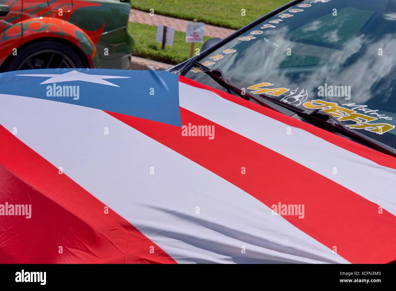 A Puerto Rican flag is proudly showcased during a car show at the Baila ...