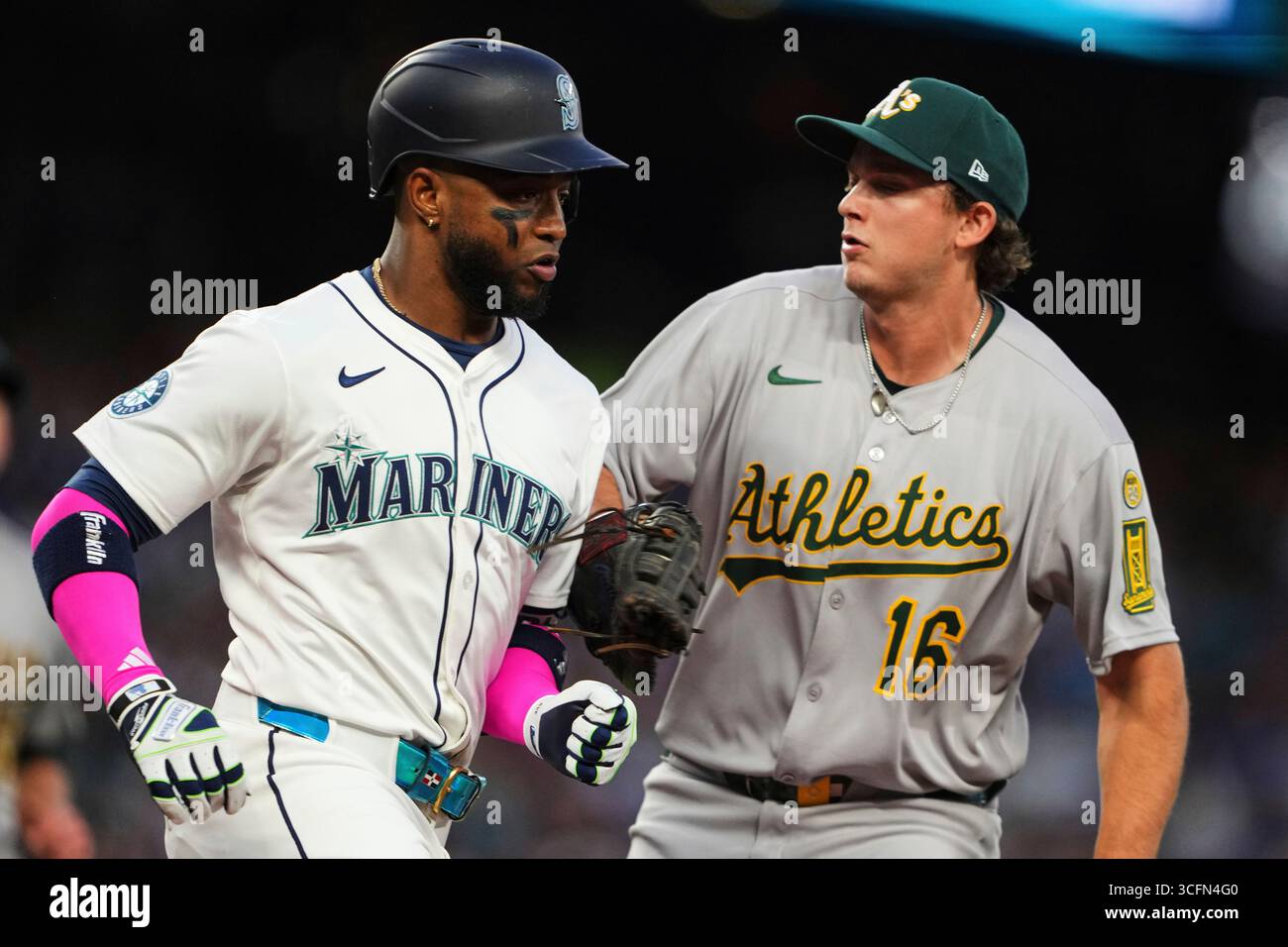 Seattle Mariners' Victor Robles is tagged out on a bunt by Athletics ...