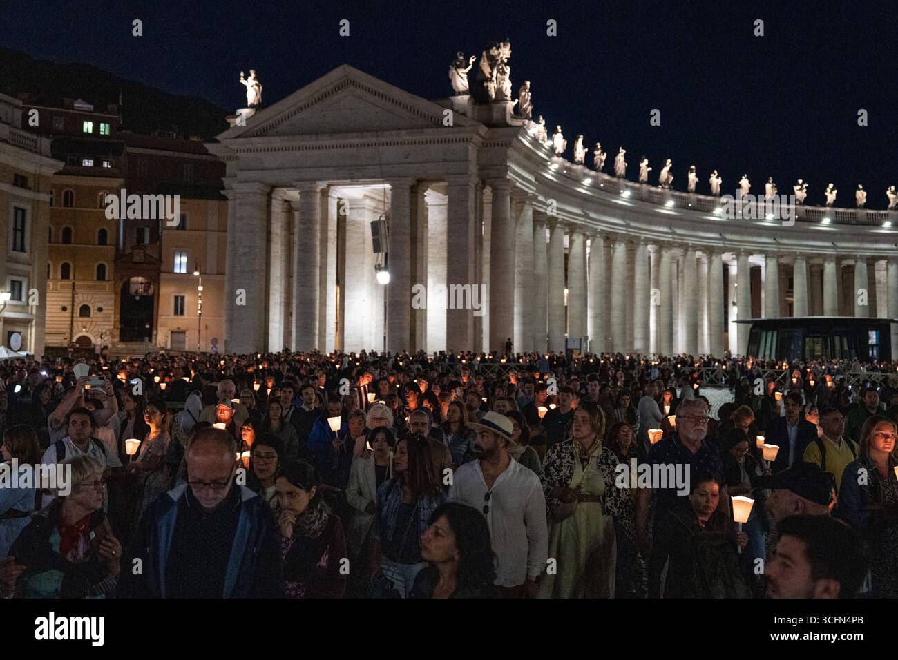 Rosary and procession at St Peters Square People holding up candles ...