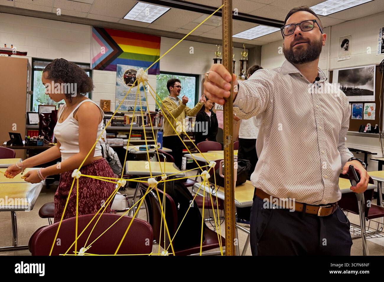 Benjamin Franklin High School teacher Chris Dier measures a structure ...