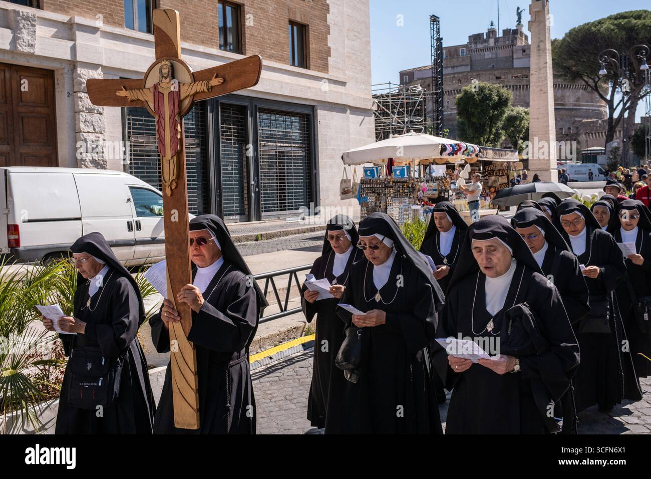 Daily Life in Rome Nuns holding up a cross on May 13, 2025 in Rome ...