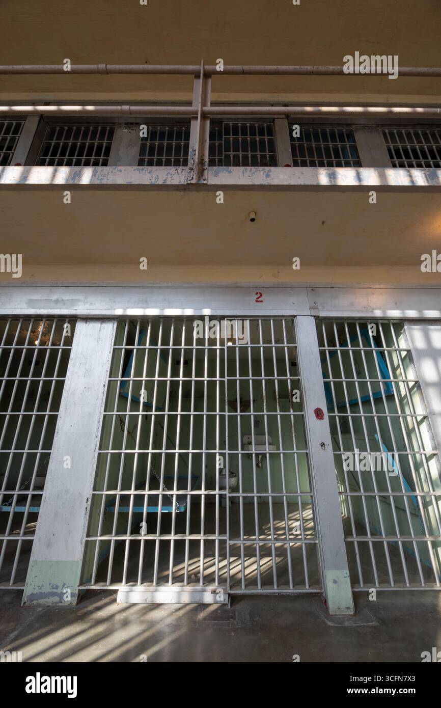 A prison cell with a barred window and a barred door Stock Photo - Alamy