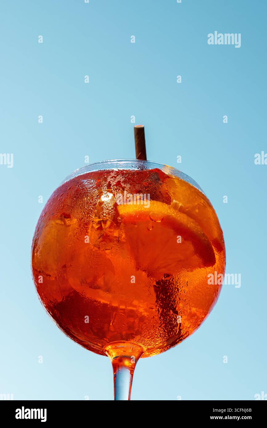 Glass of aperol spritz cocktail on blue sky background Stock Photo - Alamy