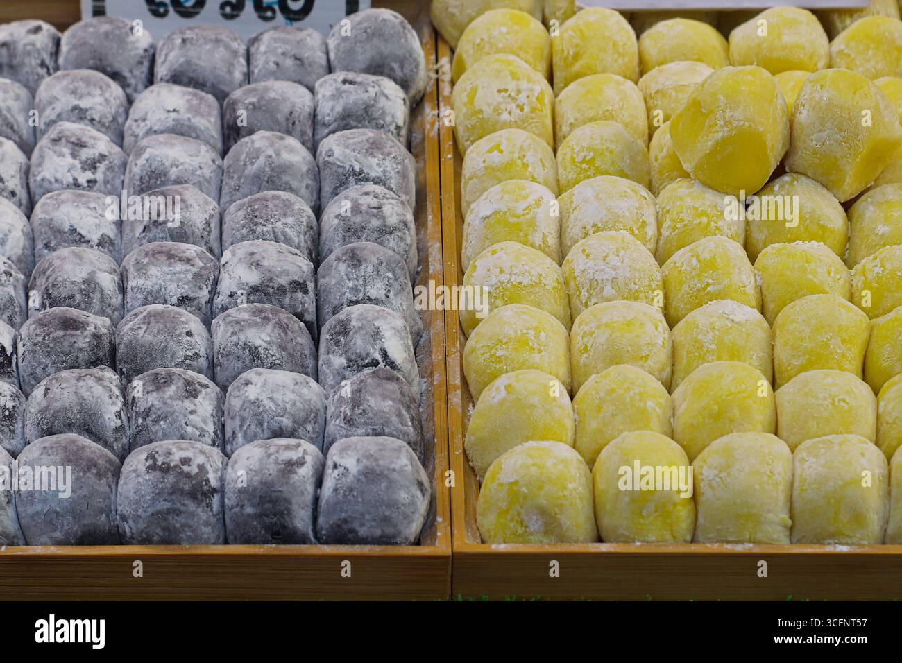 Thai mochi sweets with chocolate and durian flavors, arranged on wooden ...
