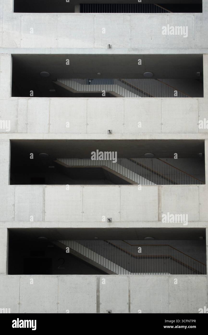 Modern concrete multi-storey car park building with visible staircases ...