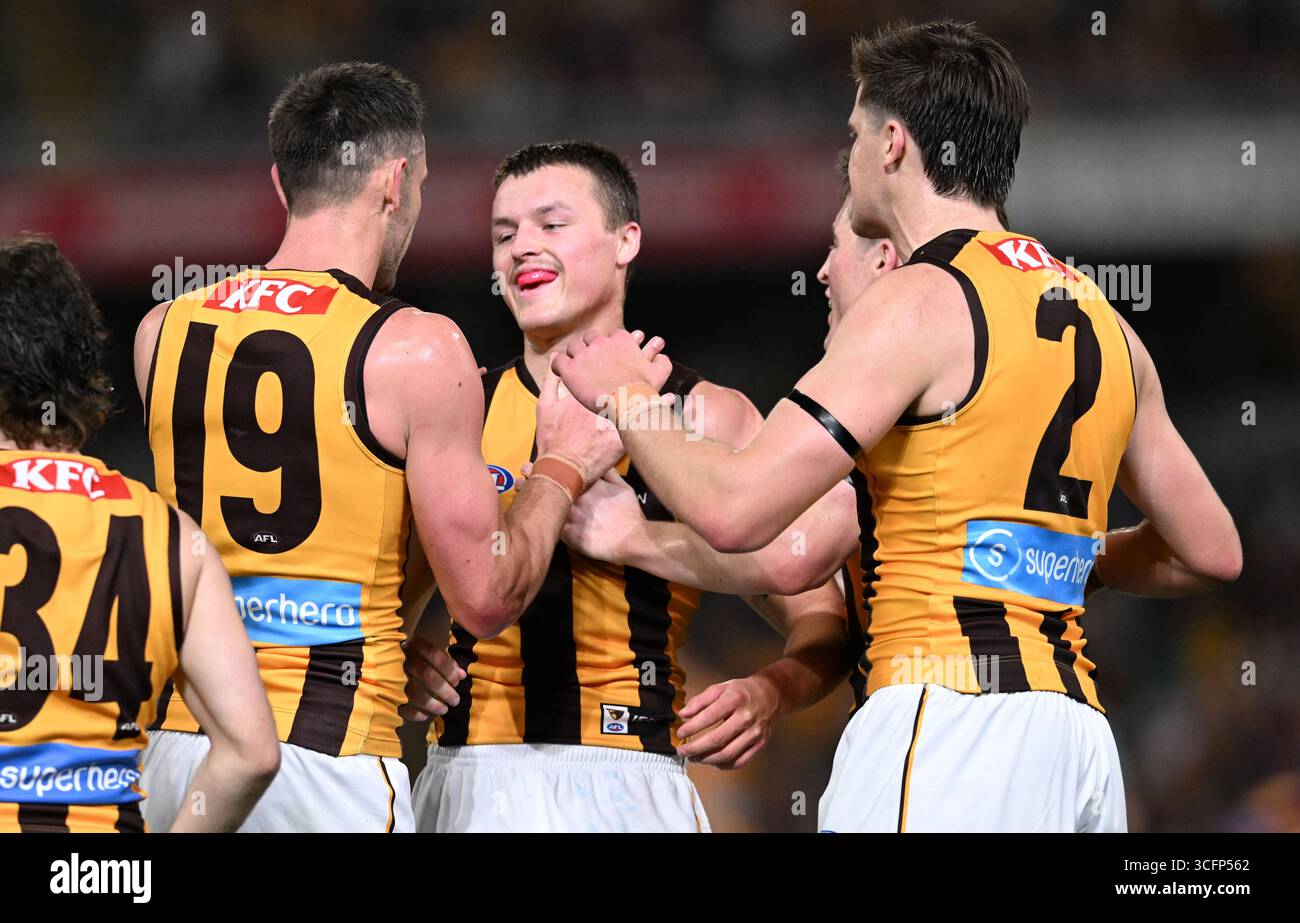 Jack Ginnivan (centre) of the Hawks celebrates kicking a goal with team ...