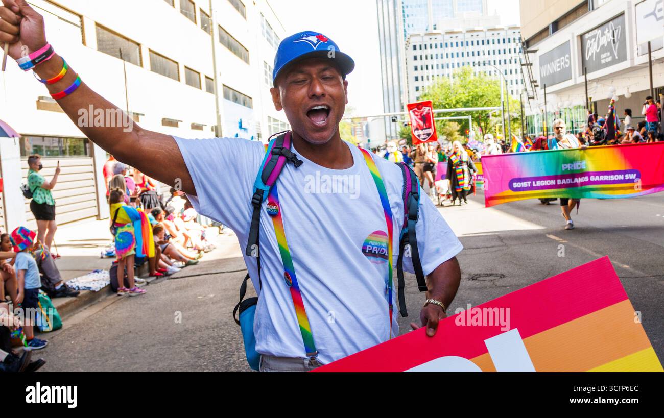 Edmonton Public Libraries employees march during the Pride parade as it ...