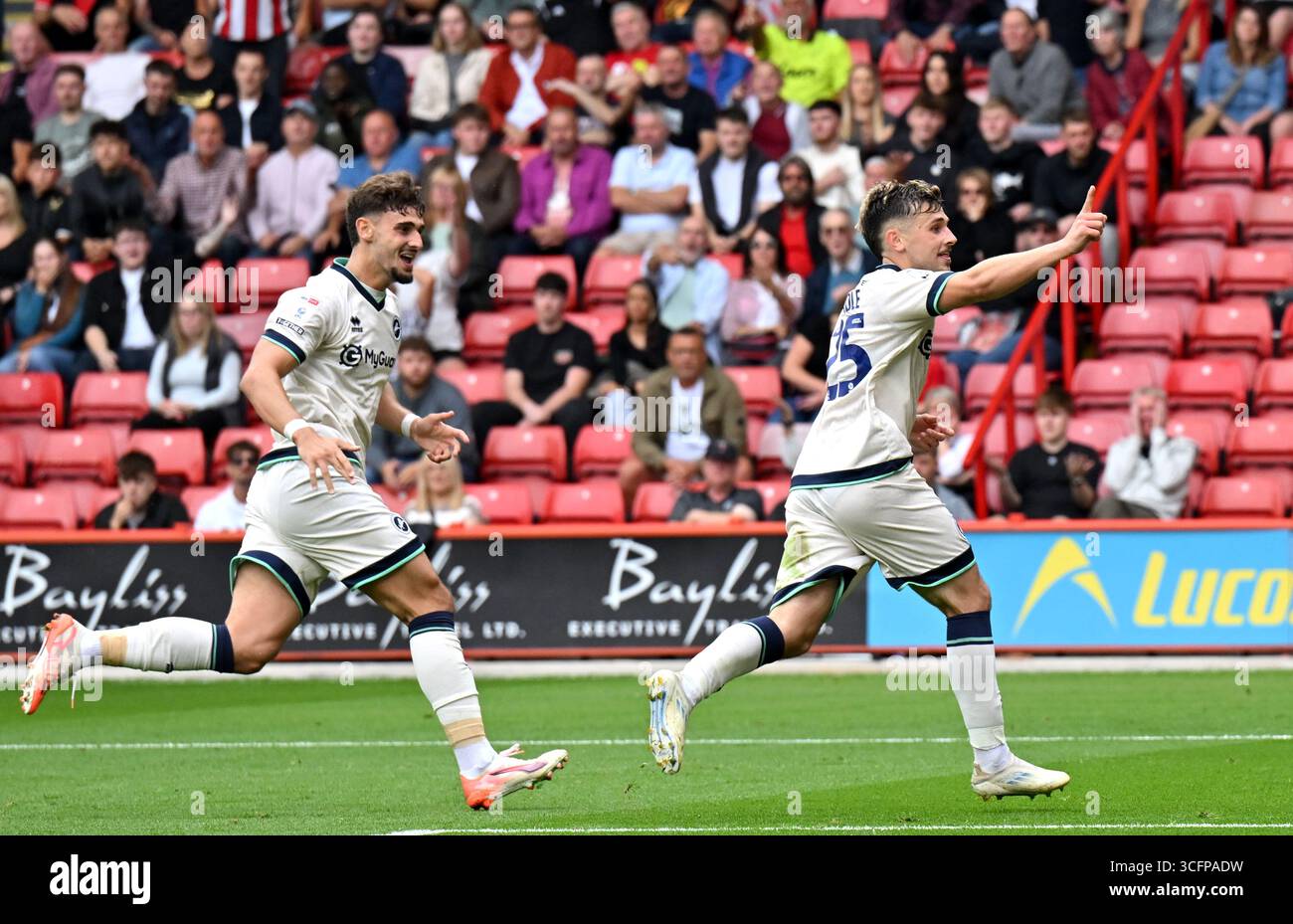 Millwall's Luke Cundle (right) celebrates his goal with Millwall's ...