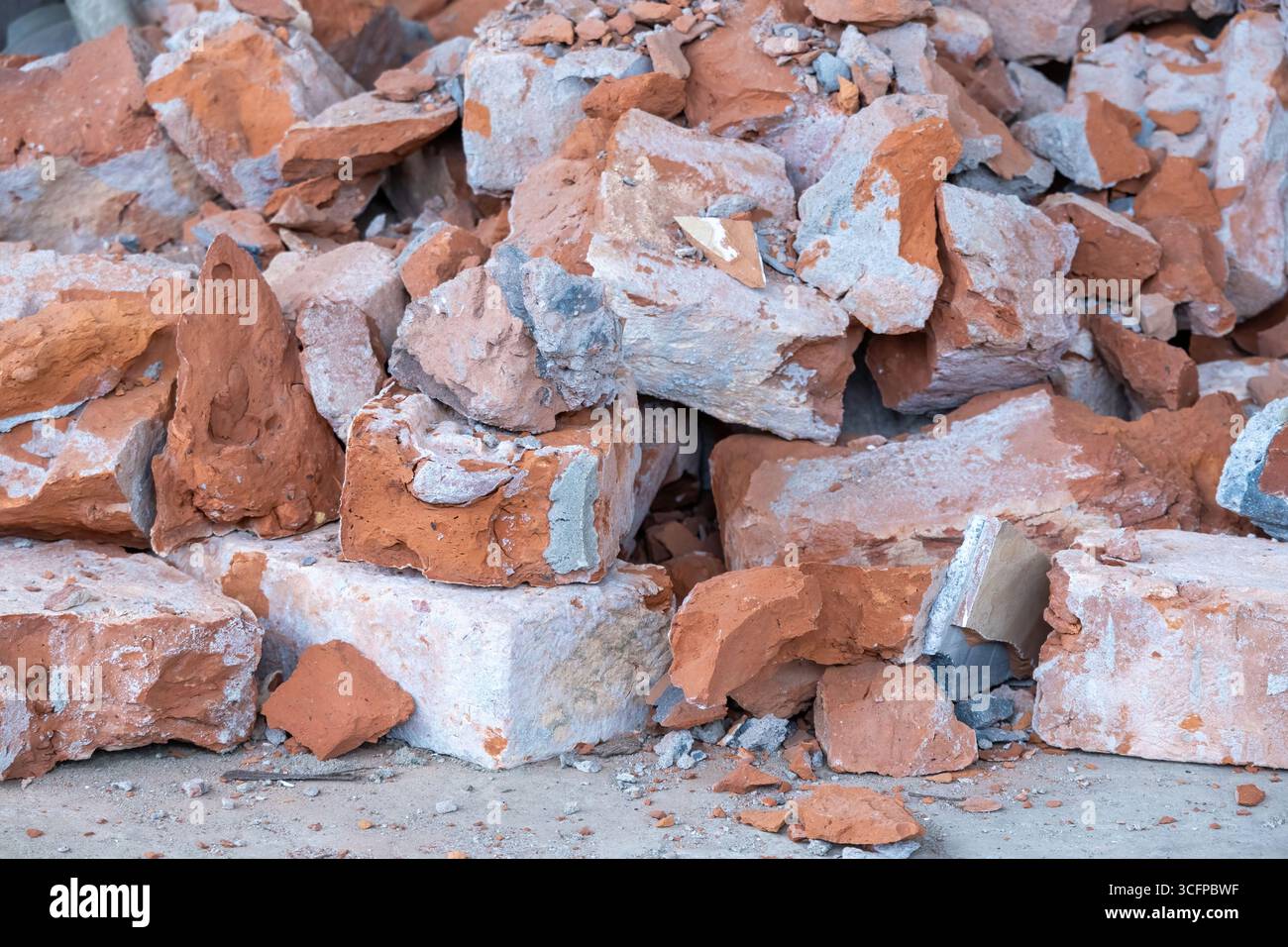 Pile of old, broken red bricks scrap. Weathered, textured rubble from ...