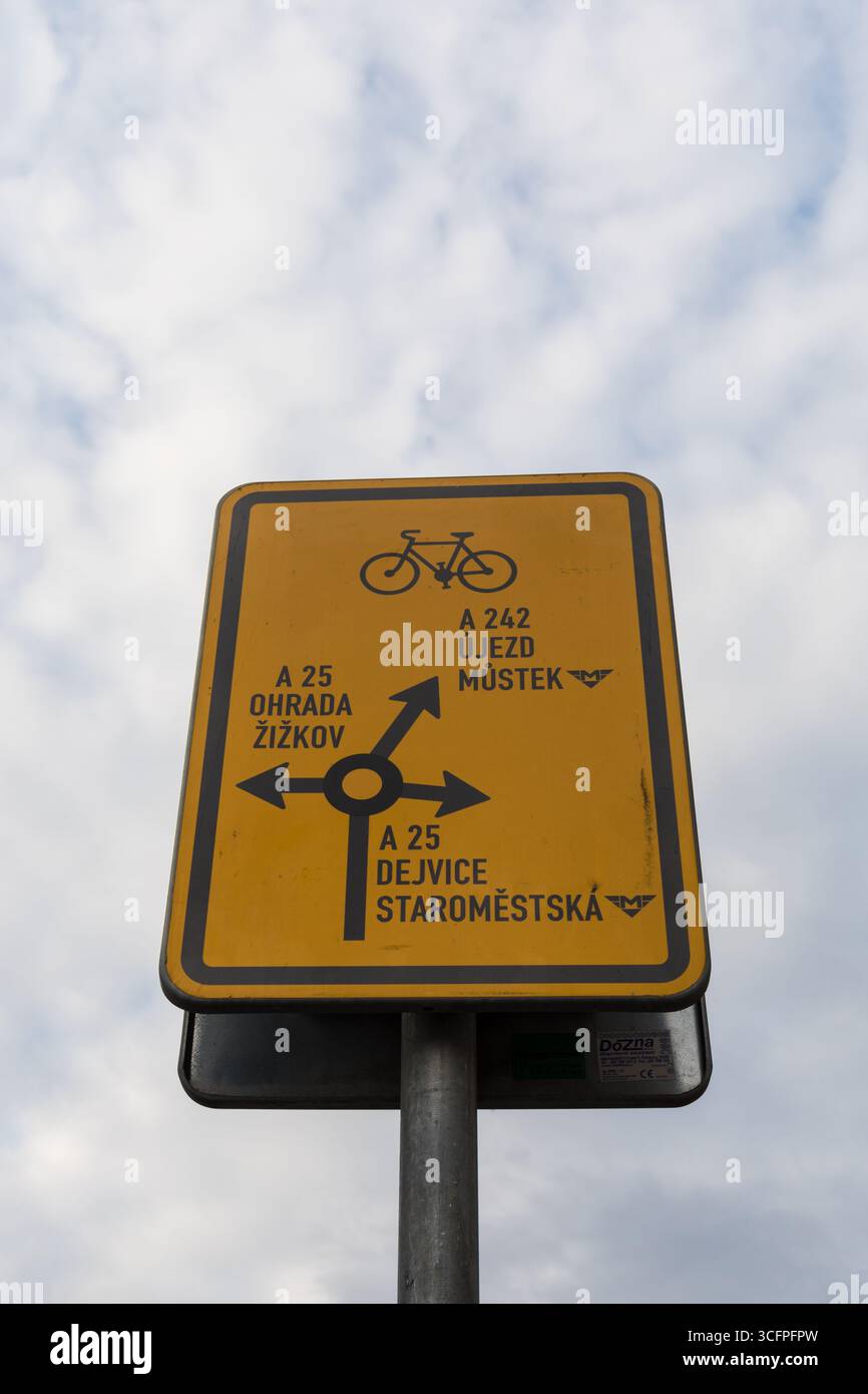A yellow cycling route sign with directional arrows indicating cycle ...