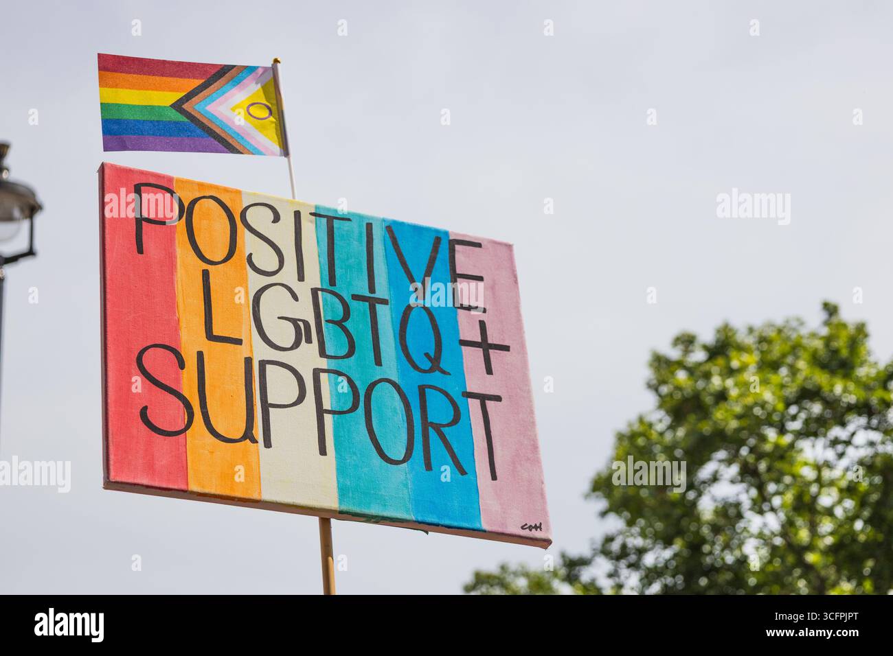 Positive LGBTQ Support sign with Progress Pride flag at inclusive ...