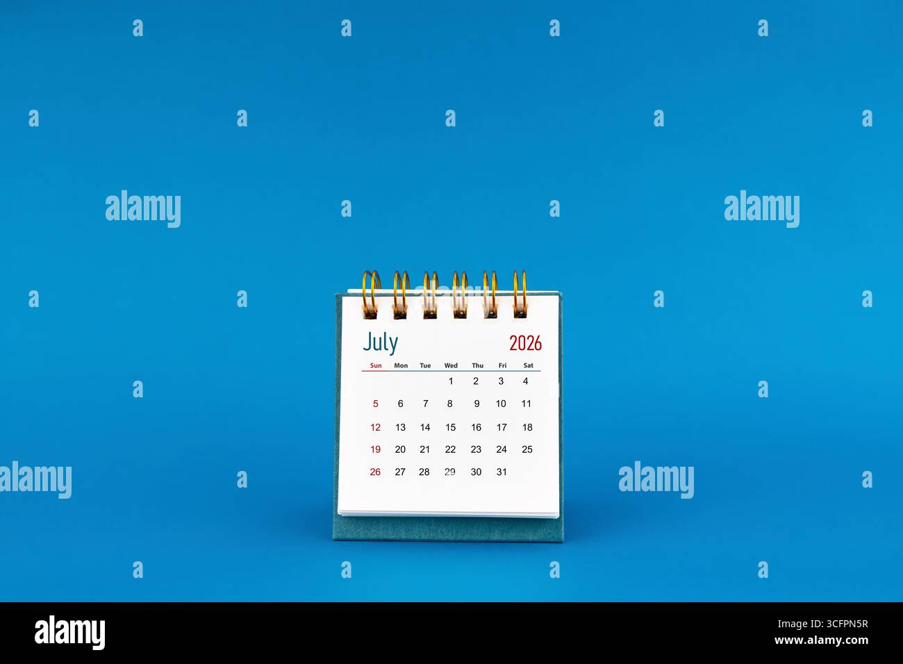 July 2026 mini desk calendar on blue background Stock Photo - Alamy