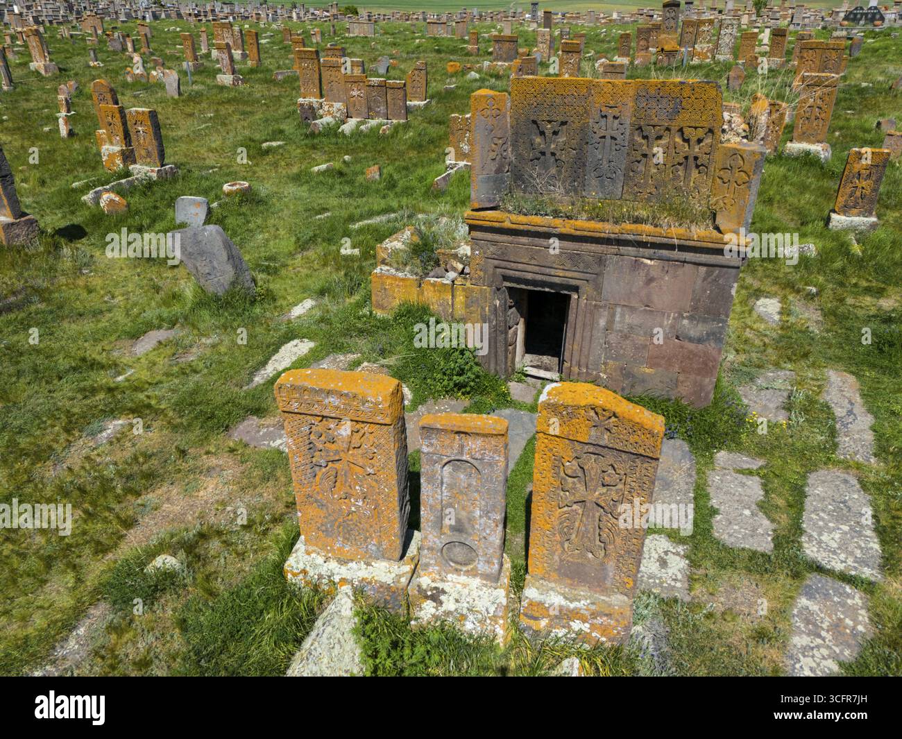Weathered gravestones and mausoleum in a historic cemetery in green ...