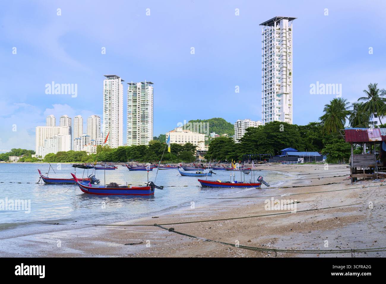 Fishing boats and George Town skyline along the Malacca Strait near ...