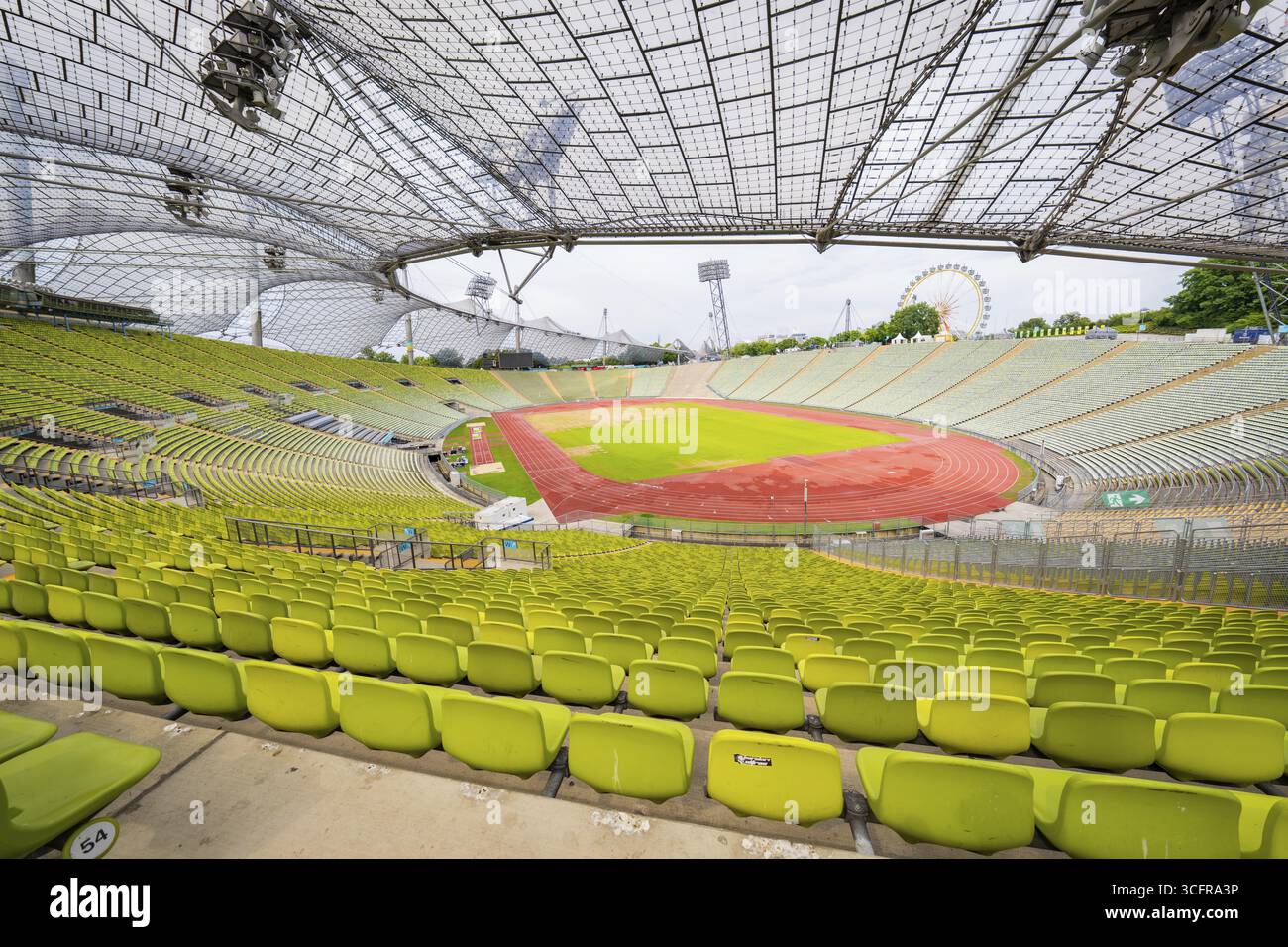 Overview of the stadium with green seats and red running track, framed ...