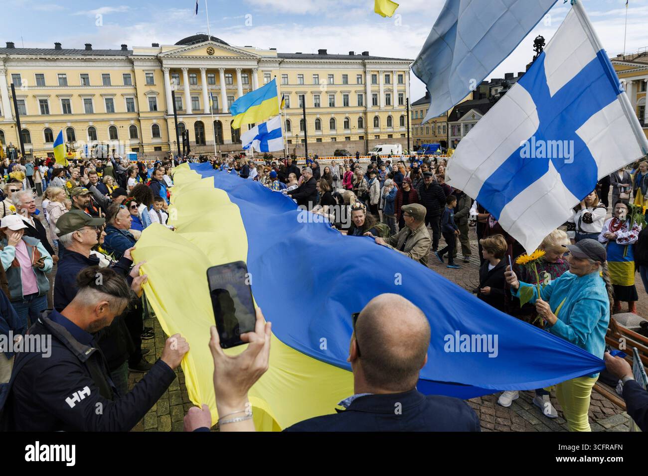 People carry flags of Ukraine and Finland marking Ukraine's ...
