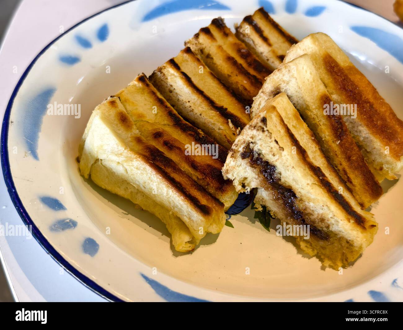 Grilled toasted bread filled with melted Chocolate on a Vintage Plate ...