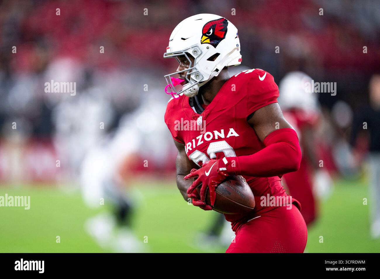 Arizona Cardinals running back Trey Benson (33) runs with the ball ...
