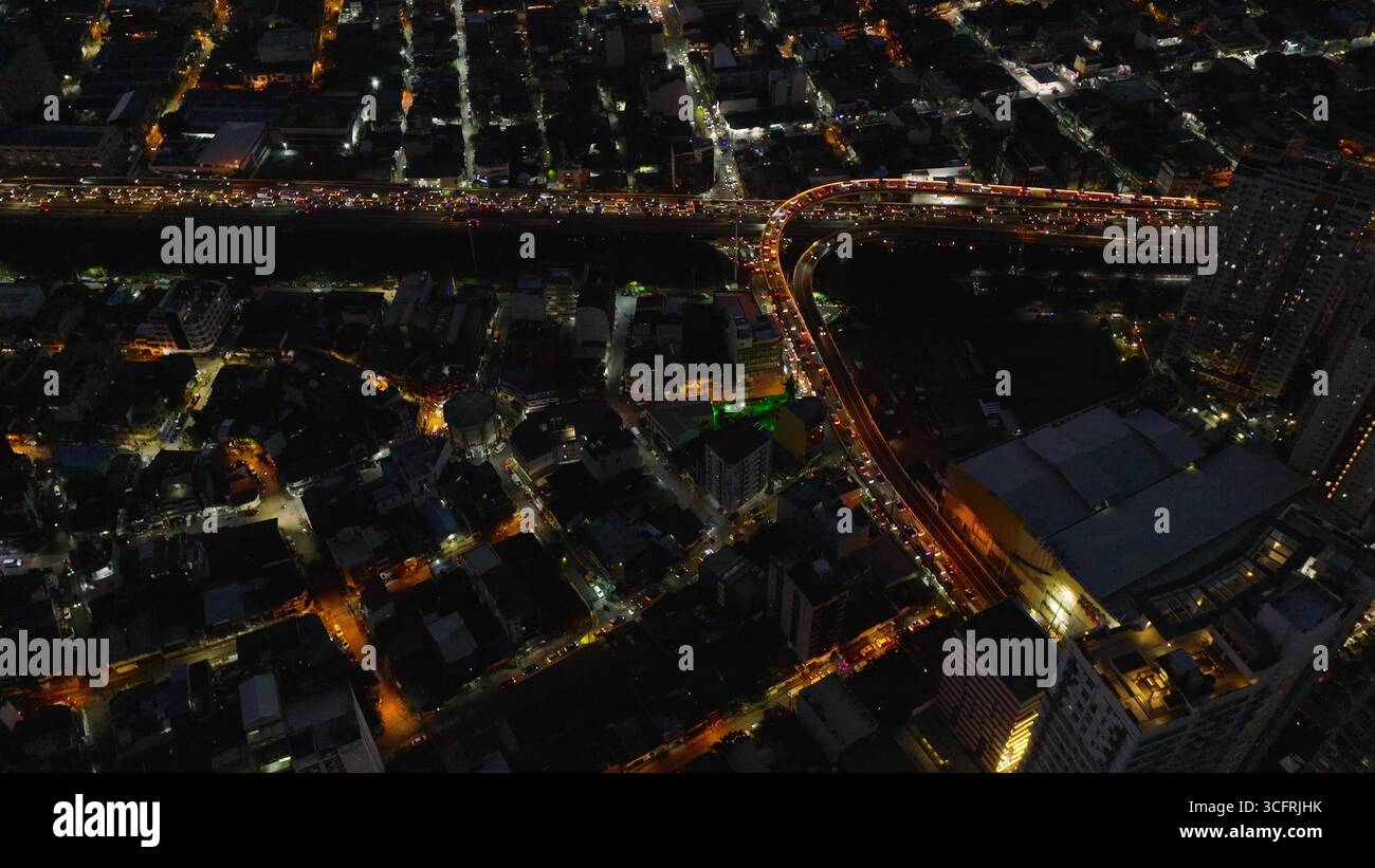 Aerial night view of Manila with traffic congestion and brightly lit ...