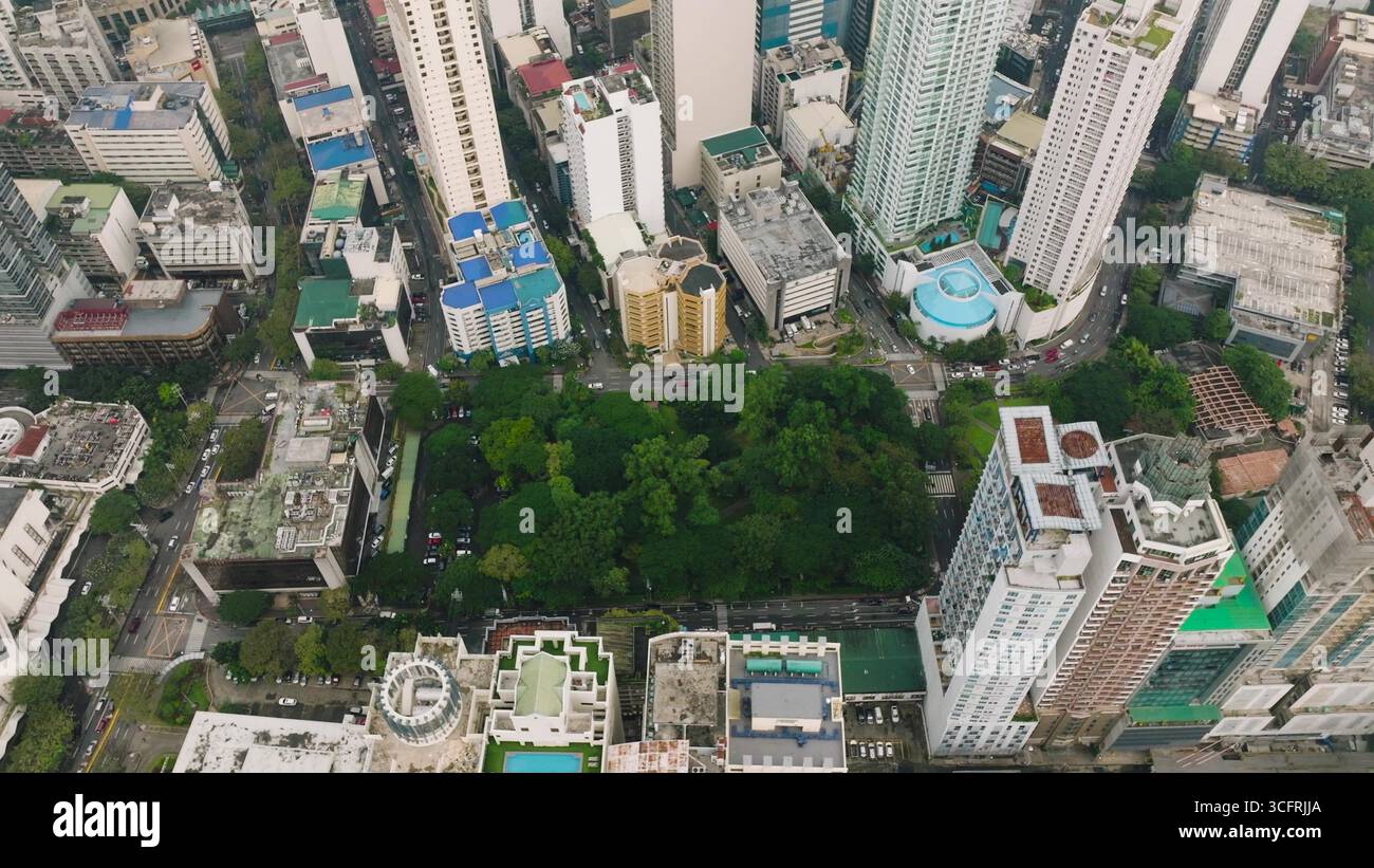 High rise buildings surround a central green park in an urban setting ...