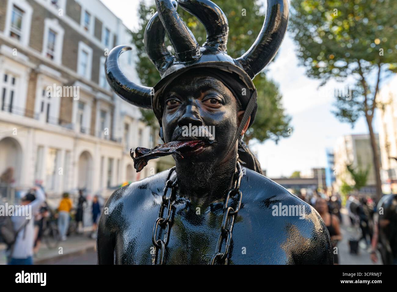 London, UK. 24 August 2025. Participants clad in black paint, horns ...