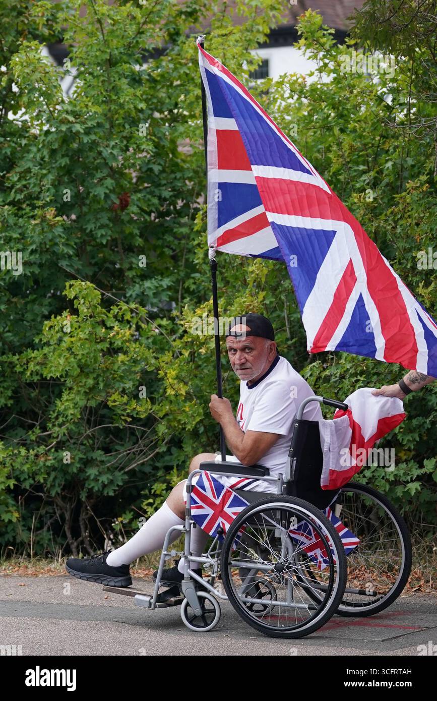 A person demonstrating under the Abolish Asylum System slogan outside ...