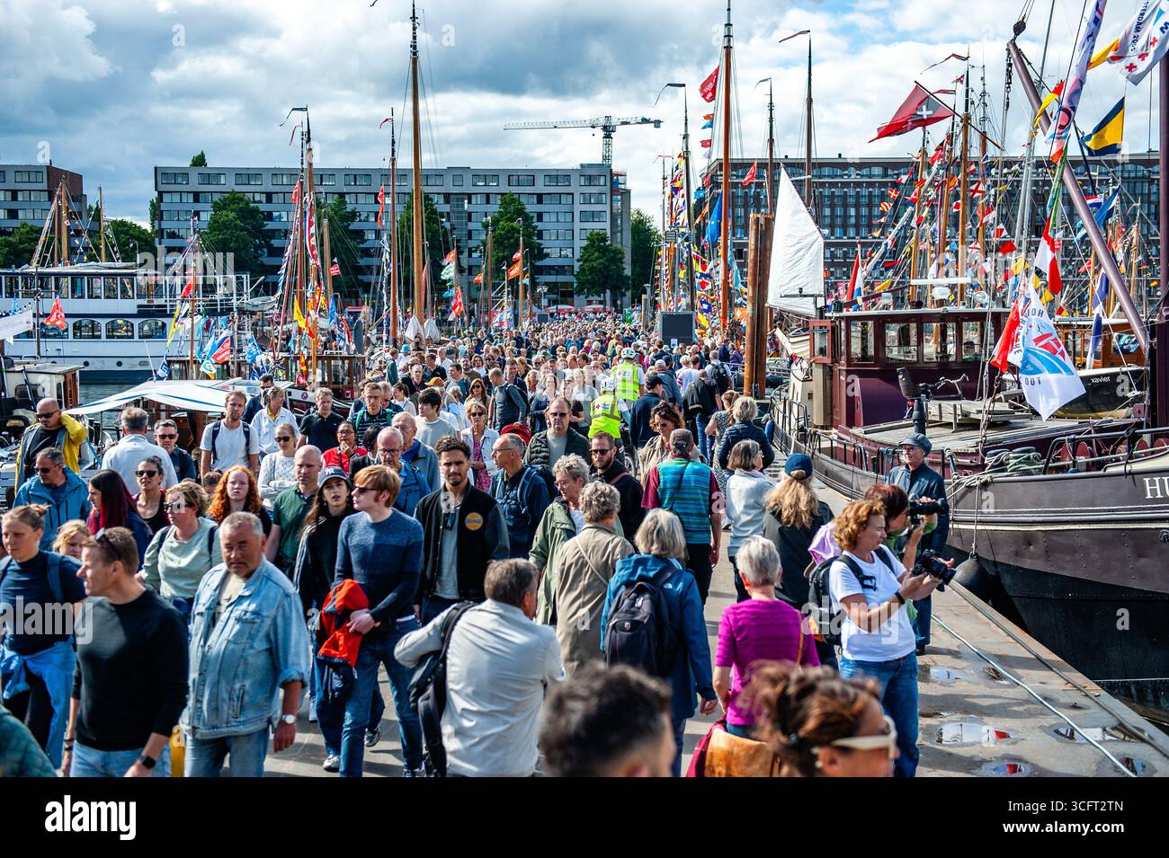 Tourists enjoy the harbour full of all kinds of ships. Held only once ...