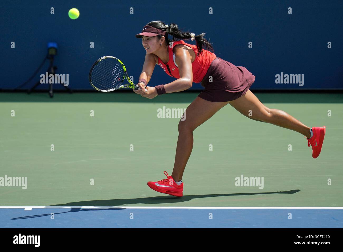 Alexandra Ella, of the Philippines, returns a shot to Clara Tauson, of ...