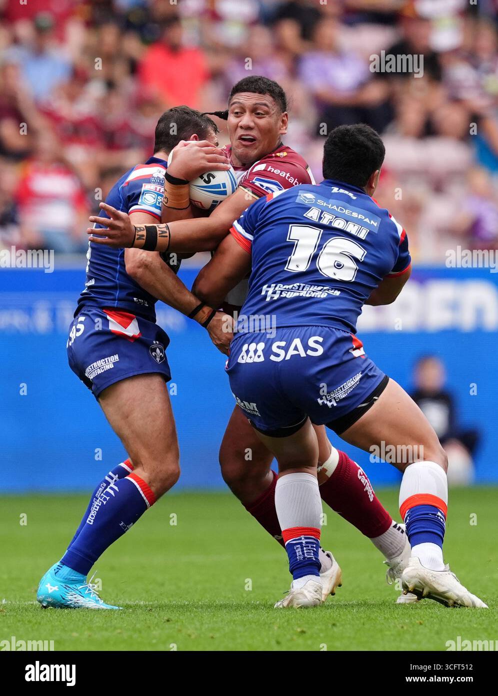 Wigan Warriors' Patrick Mago is tackled by Wakefield Trinity's Jay ...