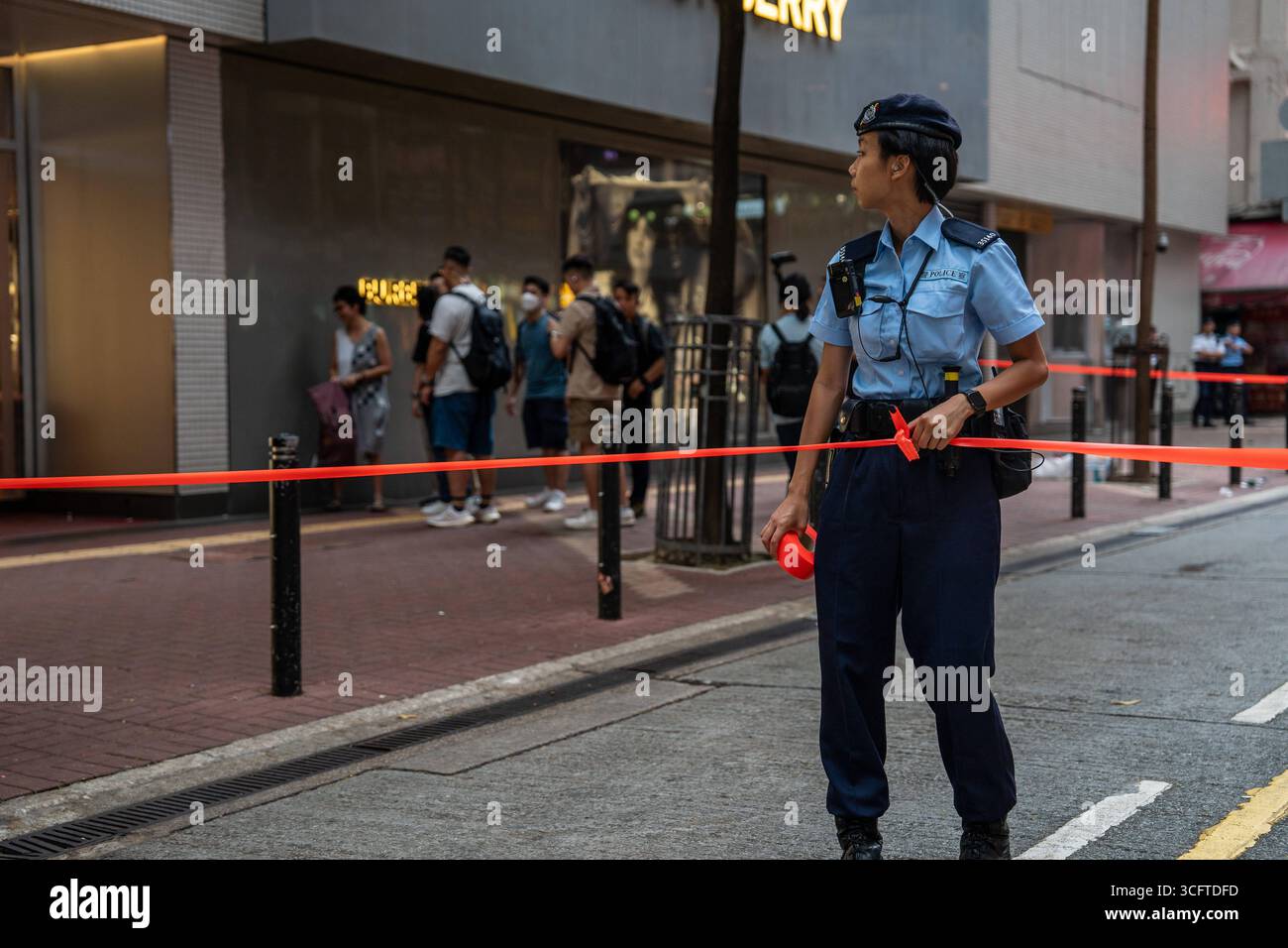 Hong Kong Before June 4 A police officer holding a police tape to form ...