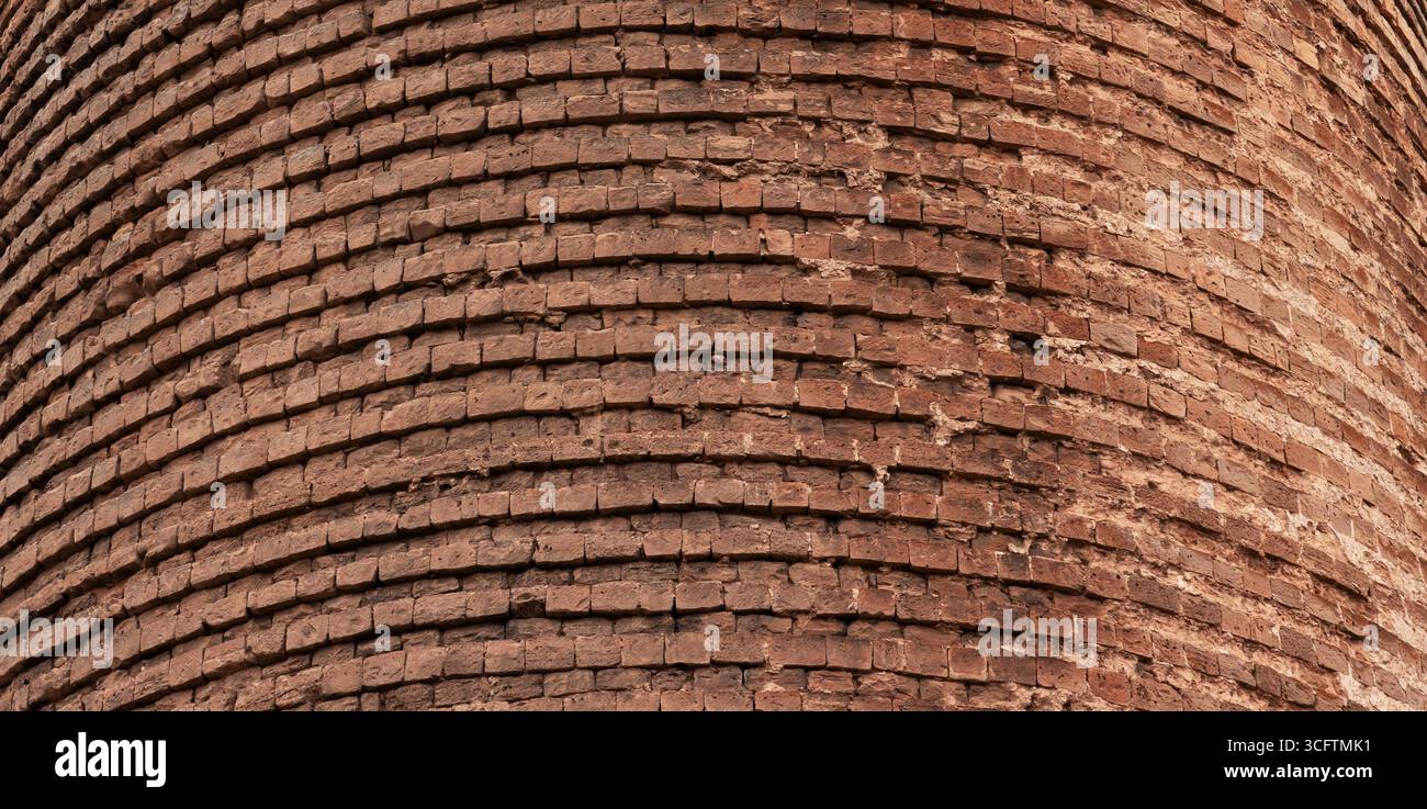 Detailed texture of an ancient round tower red bricks wall, curved ...