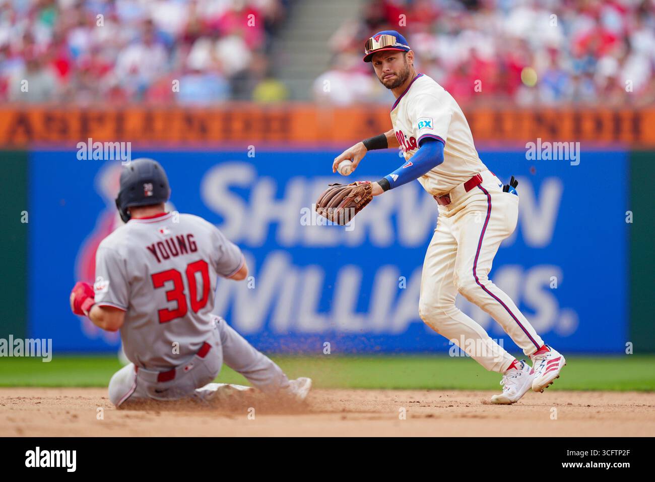 Philadelphia Phillies' Trea Turner, right, turns a double play on a ...