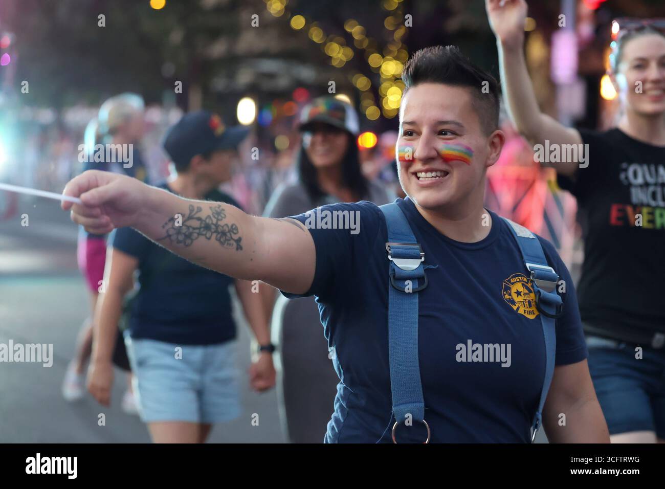 AUSTIN, TX - AUGUST 23: An Austin Fire employee walks the parade route ...