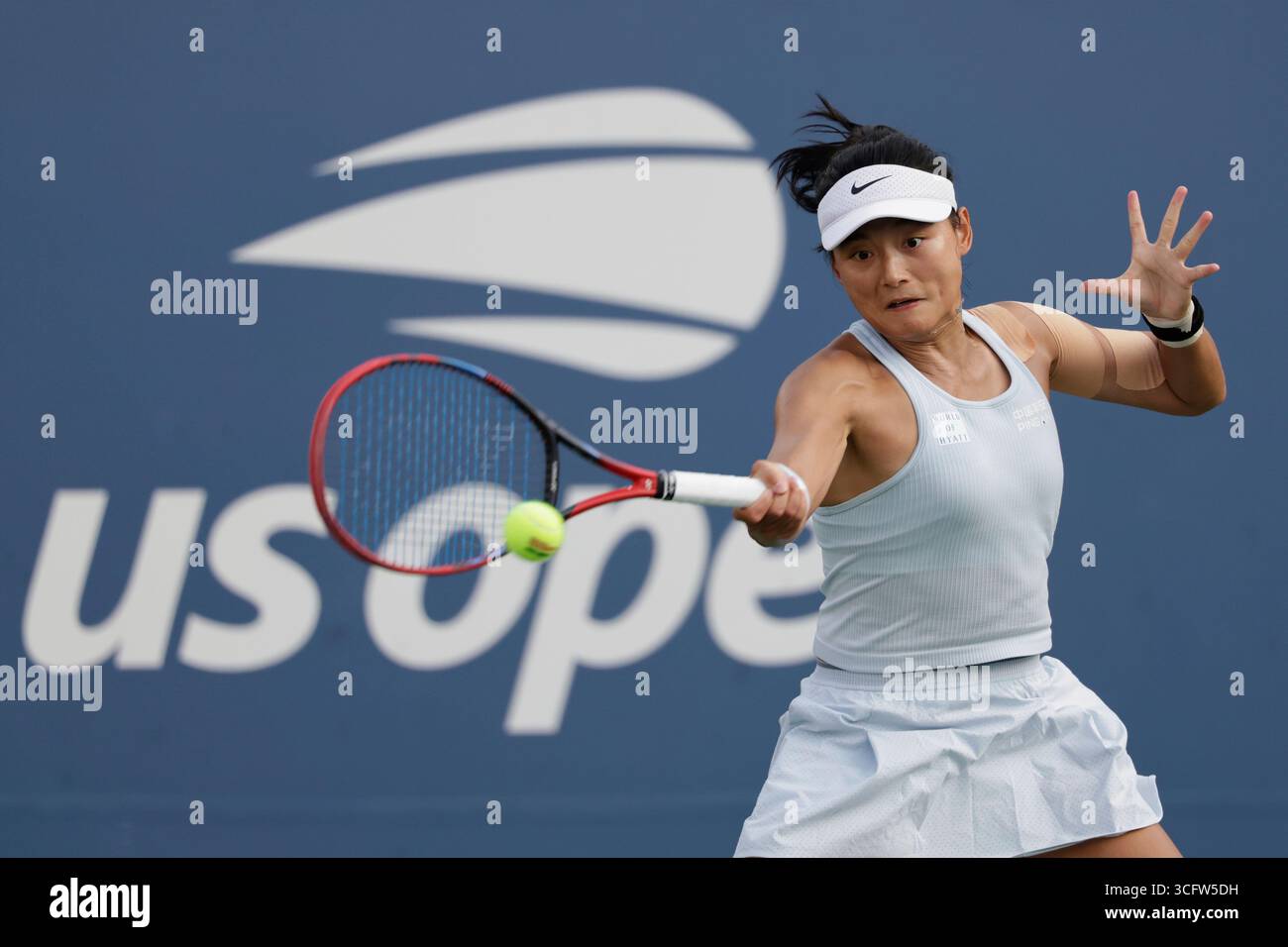 Wang Yafan, of China, returns a shot to Emma Navarro, of the United ...