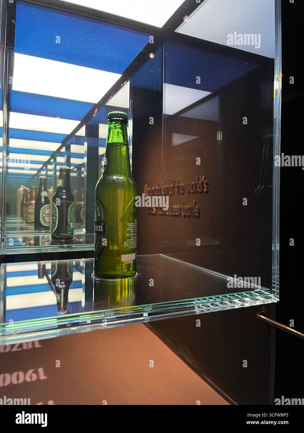 Heineken beer bottle on mirrored display shelf inside the Heineken ...