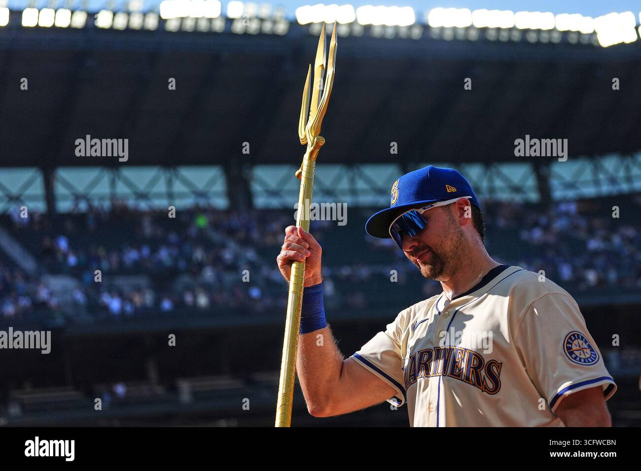 Seattle Mariners catcher Cal Raleigh lifts the trident to celebrate a ...
