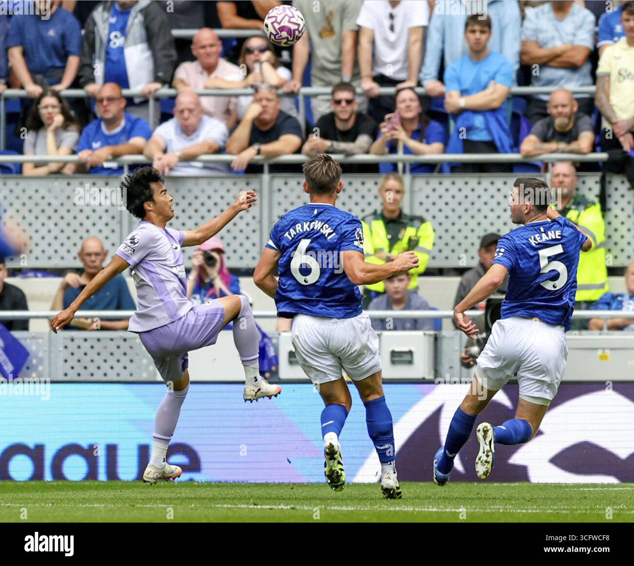 Brighton's Kaoru Mitoma (L) plays in the first half of an English ...