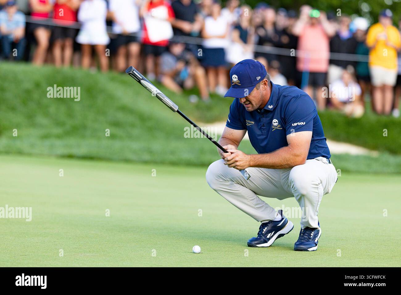 Captain Bryson DeChambeau, of Crushers GC, lines up a putt on the 18th ...
