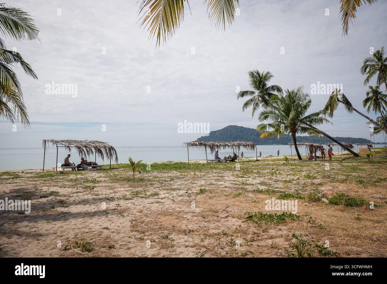 Tourists seen under huts on the private beach at the abandoned Koh ...