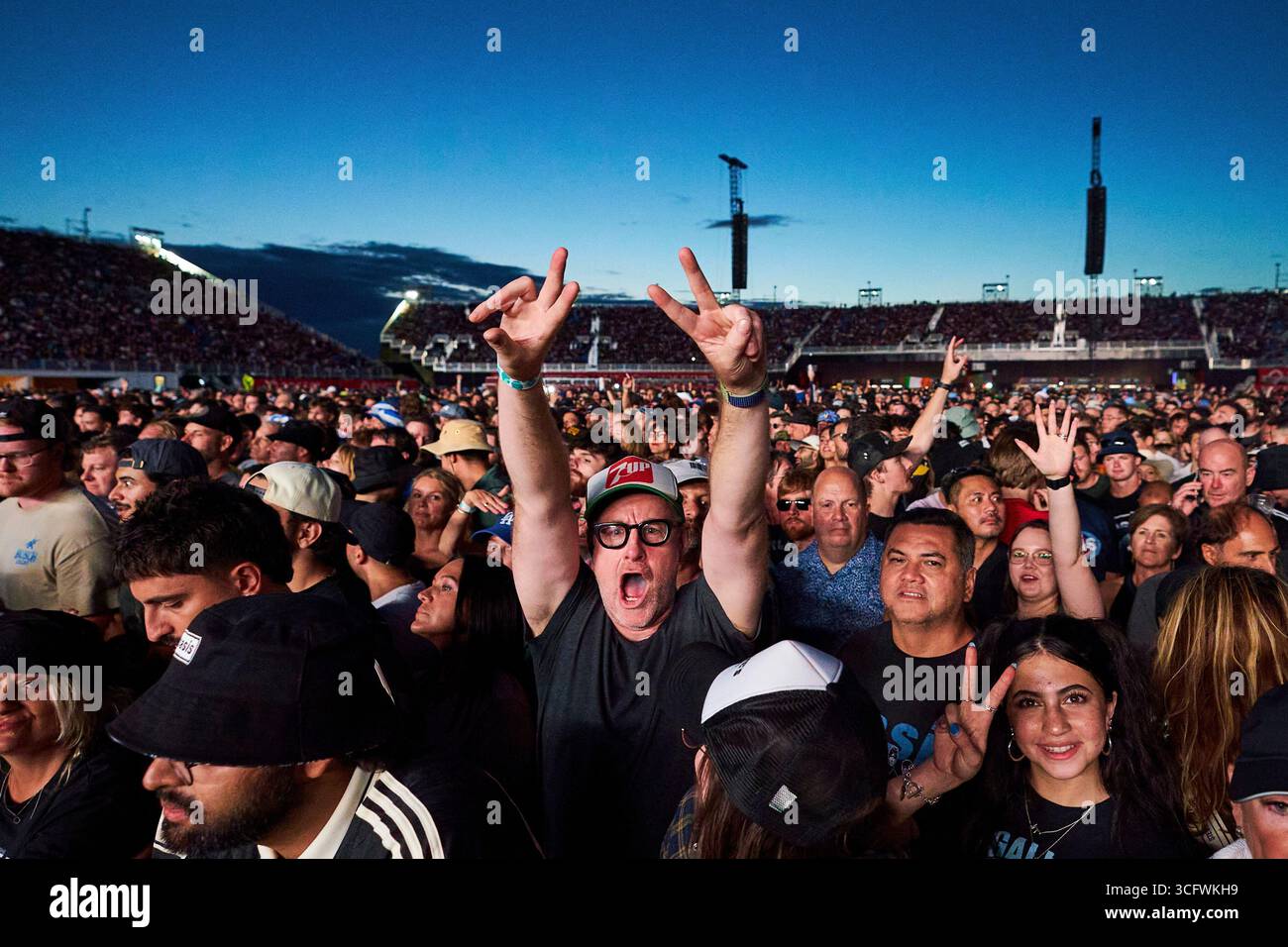 Fans gather to watch Oasis perform during their reunion tour in Toronto ...