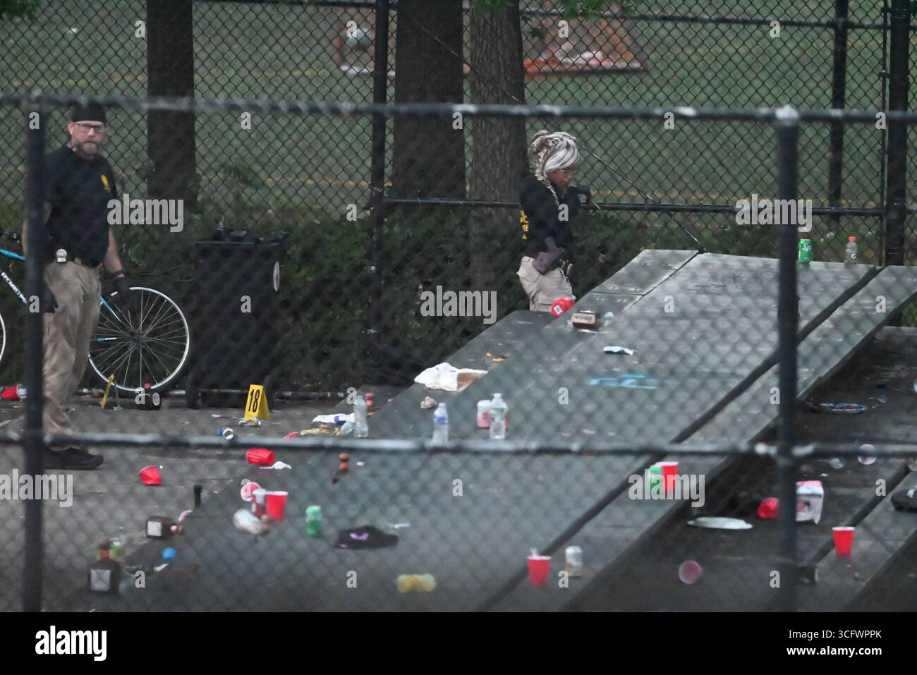 Investigators with the NYPD crime scene unit work inside the basketball ...