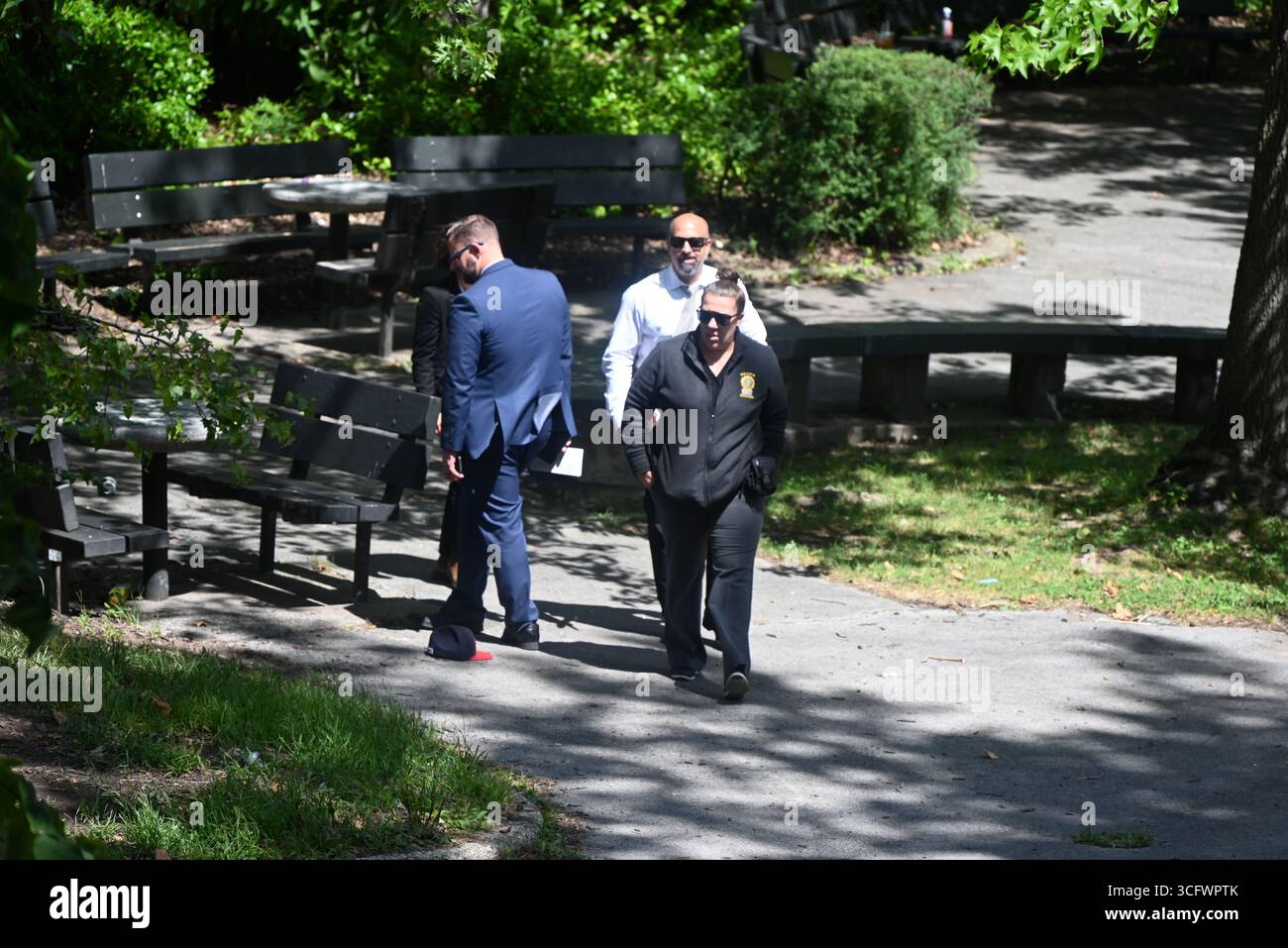 NYPD officers investigate and look over the aftermath of the scene ...