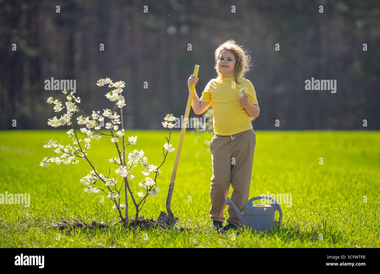 Portrait of a child planting tree. Kid gardener. Child working in the ...