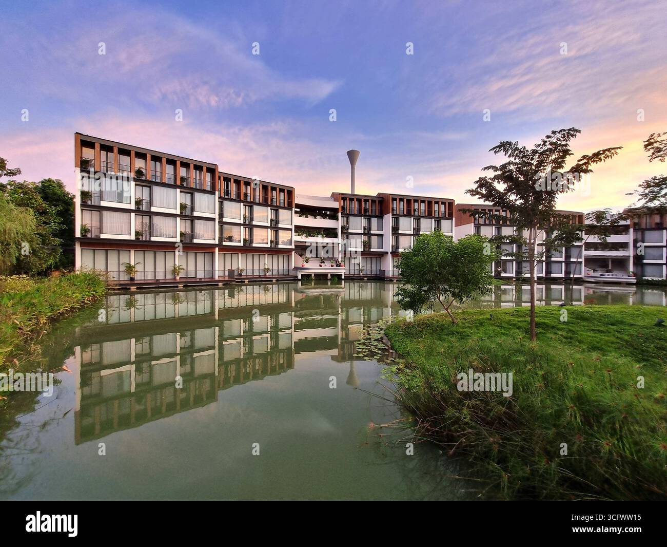 Modern beautiful luxury hotel resort building and blue sky on the river ...