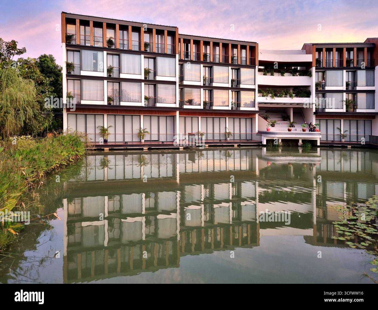 Modern beautiful luxury hotel resort building and blue sky on the river ...