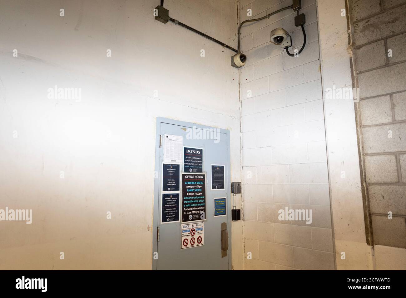 Surveillance cameras hang above the entrance to a U.S. Immigration and ...