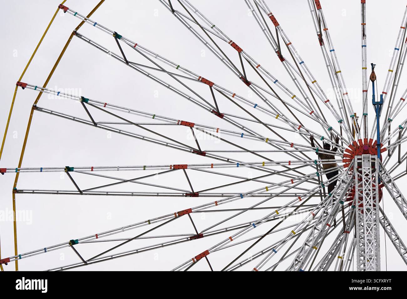 A Labourer works on a giant ferris wheel, ahead of the Hindu folk deity ...
